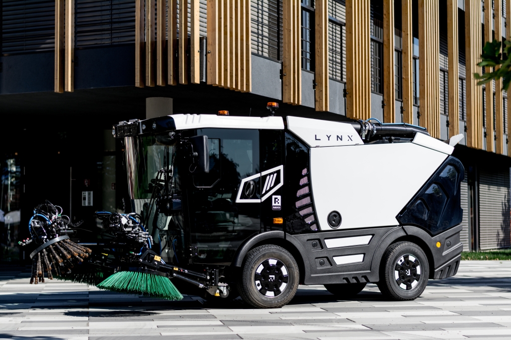 Third brush system for LYNX compact sweeper